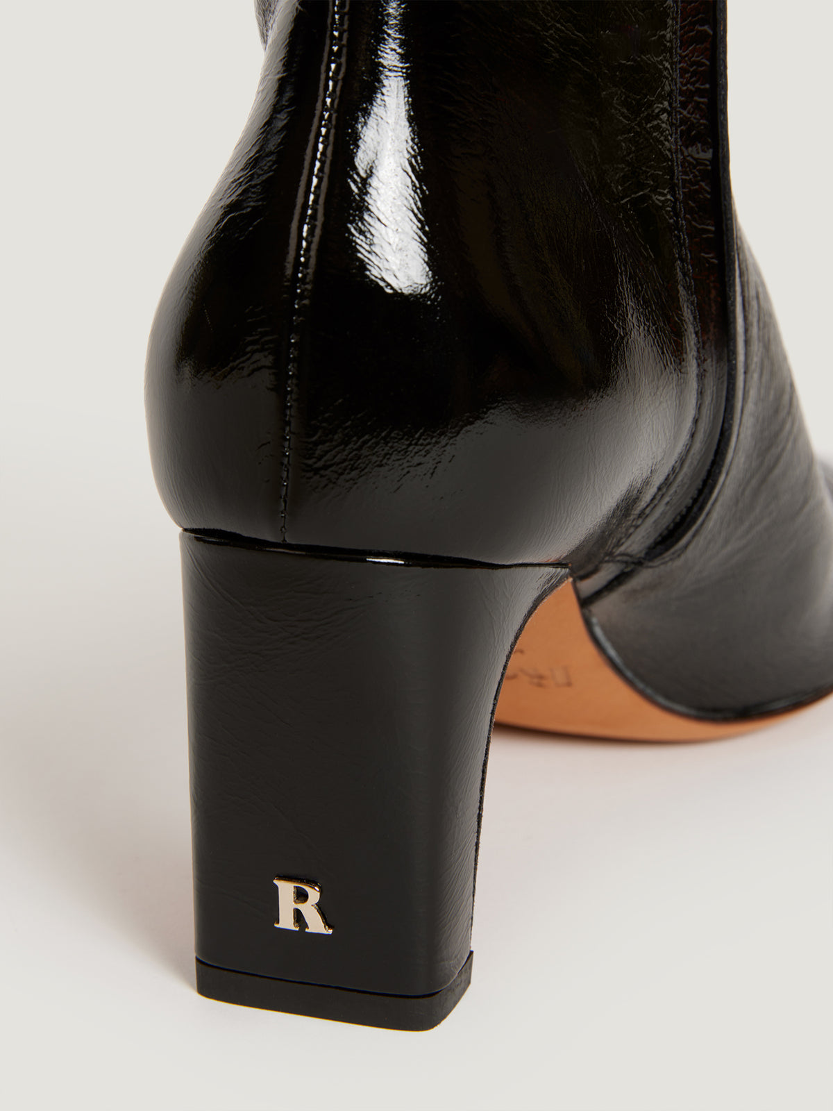 Heeled ankle boots in black patent leather | Rouje